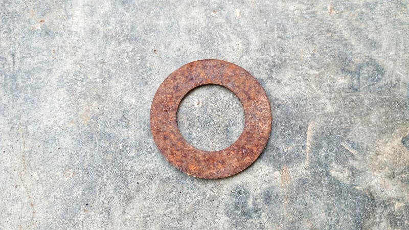 The Metal Ring Covering the Bolt Looks Rusty on the Cement Floor ...