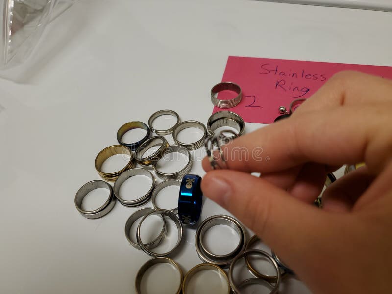 Metal rings in a pile stock photo. Image of hand, pink - 209642758