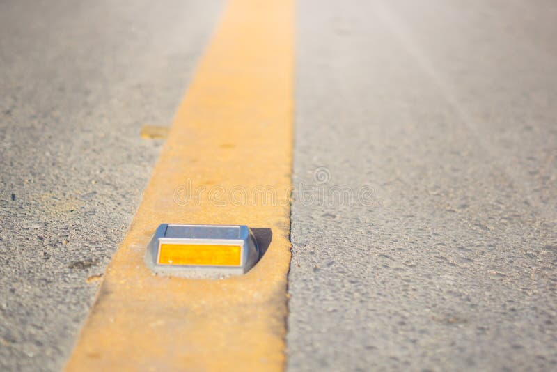 Metal Road Stud With Yellow Line On The Road Stock Photo - Image of ...