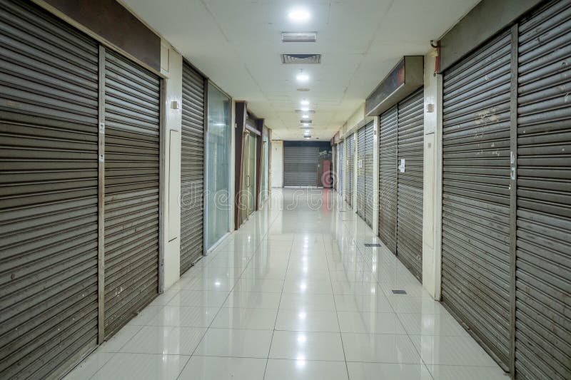 Metal Roller Shutters Rolled Down Infront of Shops Inside an Old Mall ...