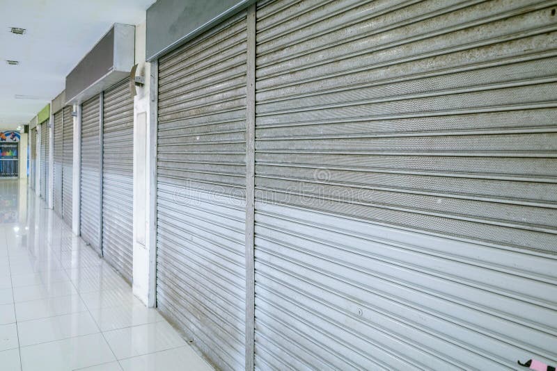 Metal Roller Shutters Rolled Down Infront of Shops Inside an Old Mall ...