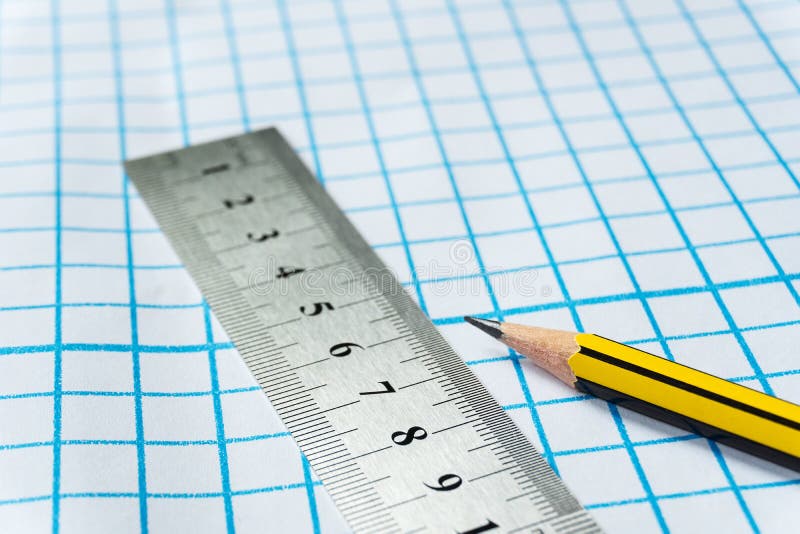 Metal Ruler and a Pencil on Graph Paper. Stock Photo - Image of ...