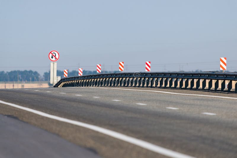 A Metal Separator of Directions on an Asphalt Road between Cities. Road ...