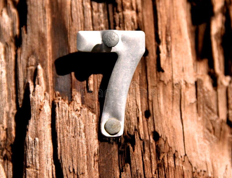 Metal Seven is Embedded in Rustic Post Stock Image - Image of rough ...