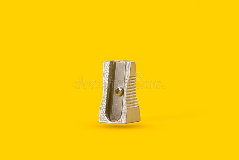 Metal Sharpener Floating on a Yellow Background Stock Photo - Image of ...