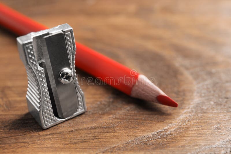 Metal Sharpener and Red Pencil on Wooden Table, Closeup. Space for Text ...