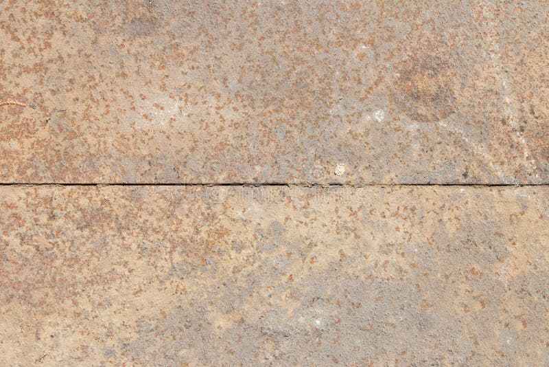 A Metal Sheet Covered in Rust and Sand is Divided into Two by a ...