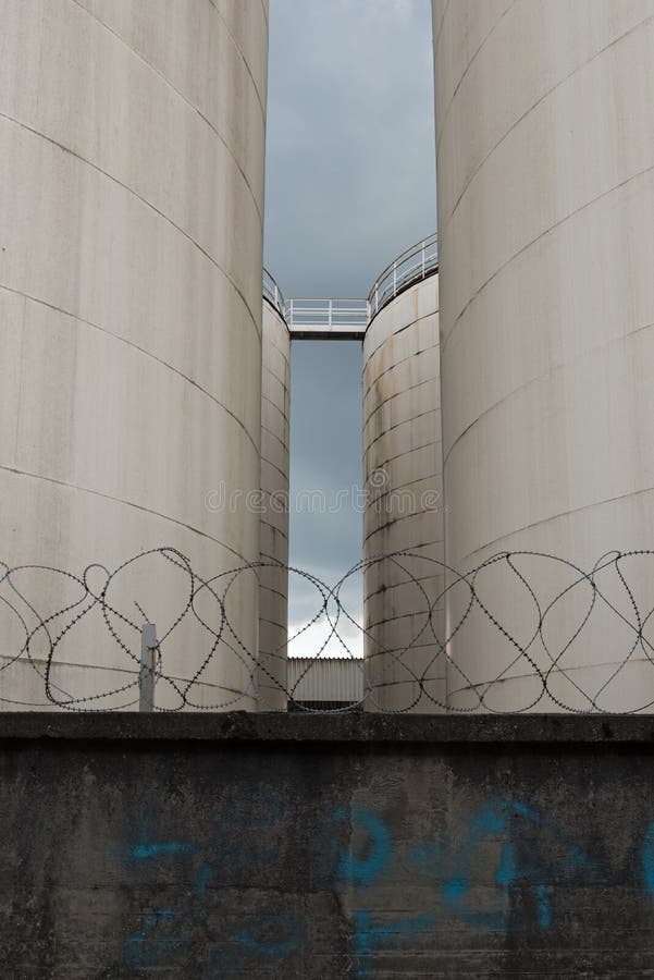 Metal Silo, Store Behind a Concrete Wall with Barbed Wire Stock Image ...