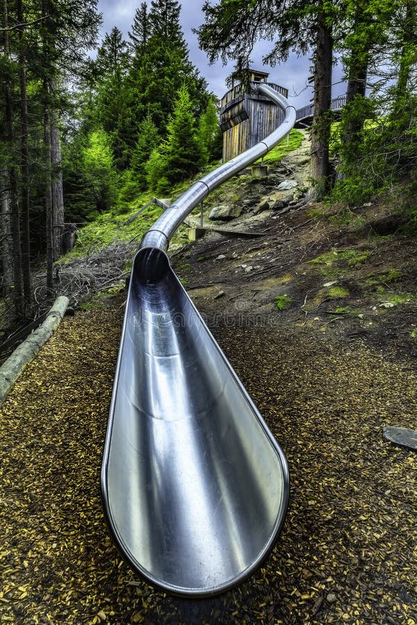 Metal Slide in the Alpine Forest Stock Photo - Image of amusement ...