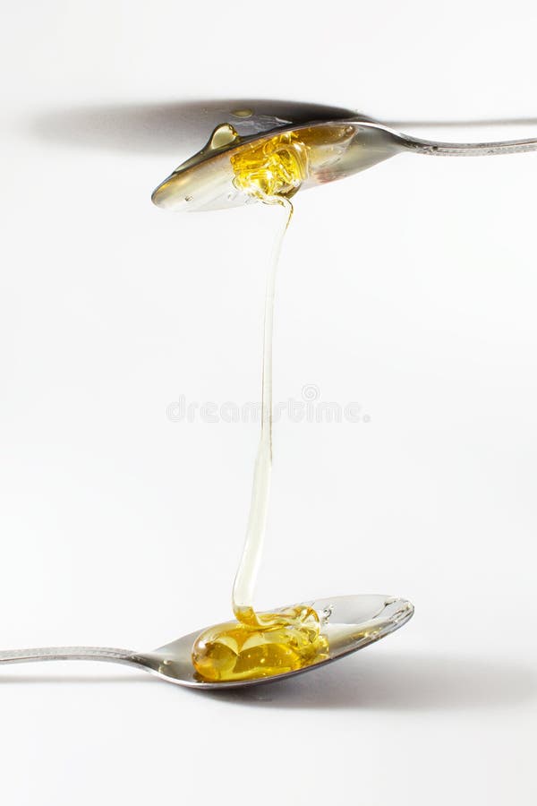 Metal Spoon with Flowing Down Honey on a White Background. Stock Image ...