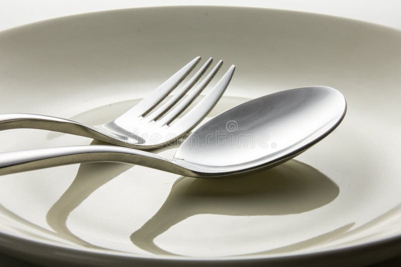 Metal Spoon and Fork on Dish. Stock Image - Image of dinner, flatware ...