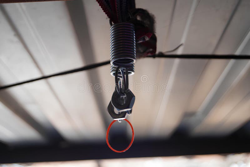 Metal Spring and Clip Attached To a Wire Indoors Stock Photo - Image of ...