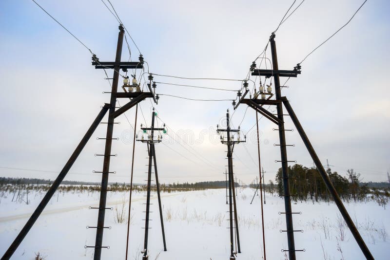 Metal Supports of Overhead Power Lines in the Winter on Field. Stock ...