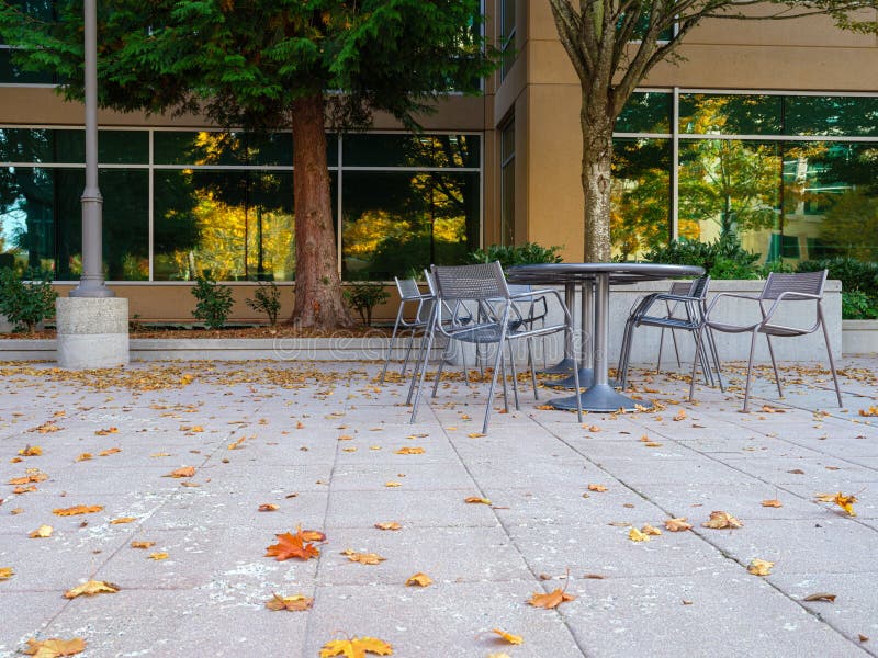 Metal Table and Chairs Outside an Office Building in Autumn Stock Photo ...