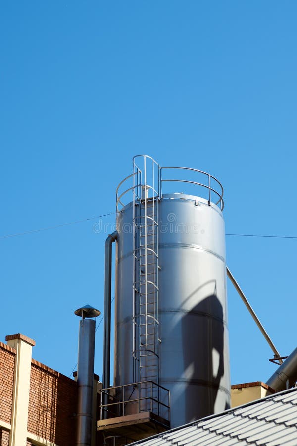 Metal tank in a factory stock image. Image of industry - 276765443