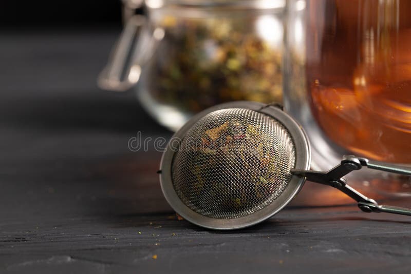 Metal Tea Strainer on Black Wooden Table Stock Photo - Image of herbal ...