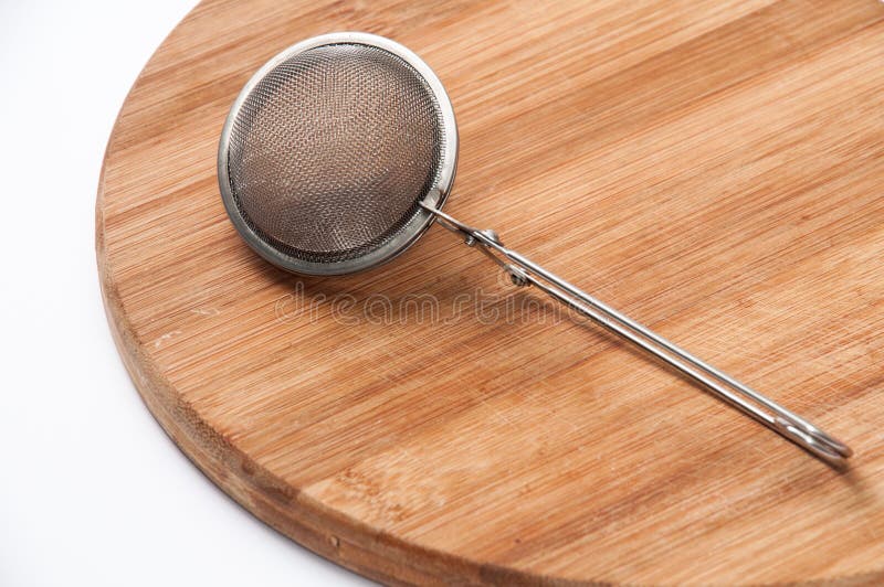 METAL TEA STRAINER CLAMP WOODEN BOARD Stock Image - Image of shiny ...