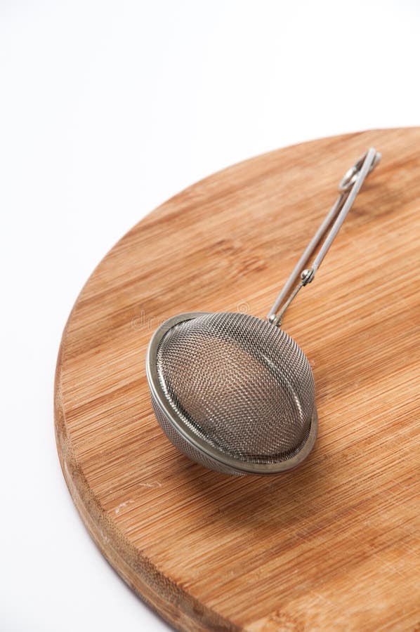 METAL TEA STRAINER CLAMP WOODEN BOARD Stock Photo - Image of wooden ...
