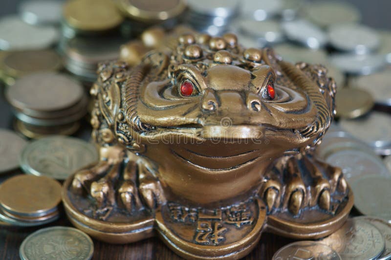 A Metal Toad Next To a Stack of Coins. Stock Photo - Image of bronze ...