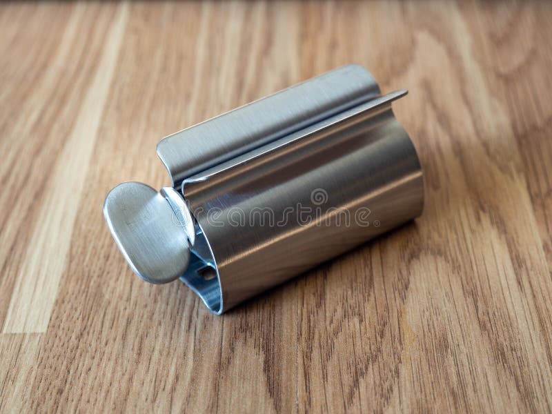 Metal Toothpaste Tube Squeezer Stock Photo - Image of shaft, dispenser ...