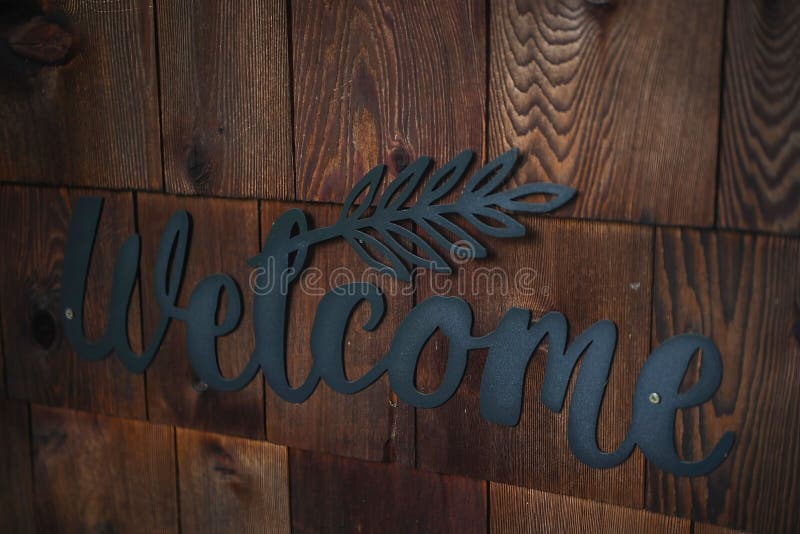 Metal Welcome Sign on a Wood Shingle Wall Stock Photo - Image of ...