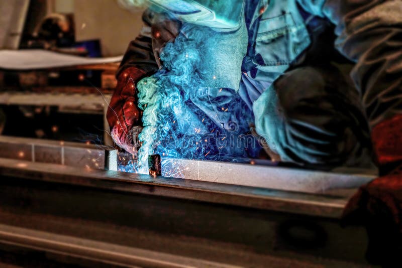 A Metal Welding Worker is Engaged in Welding in a Workshop Stock Image ...