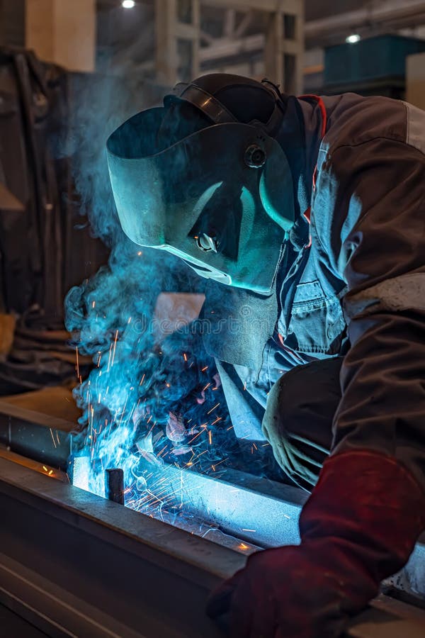 A Metal Welding Worker is Engaged in Welding in a Workshop Stock Photo ...