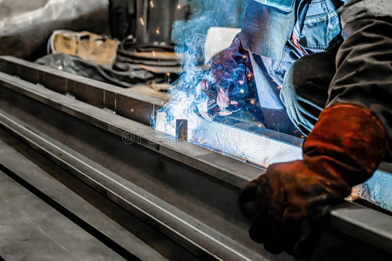 A Metal Welding Worker is Engaged in Welding in a Workshop Stock Image ...