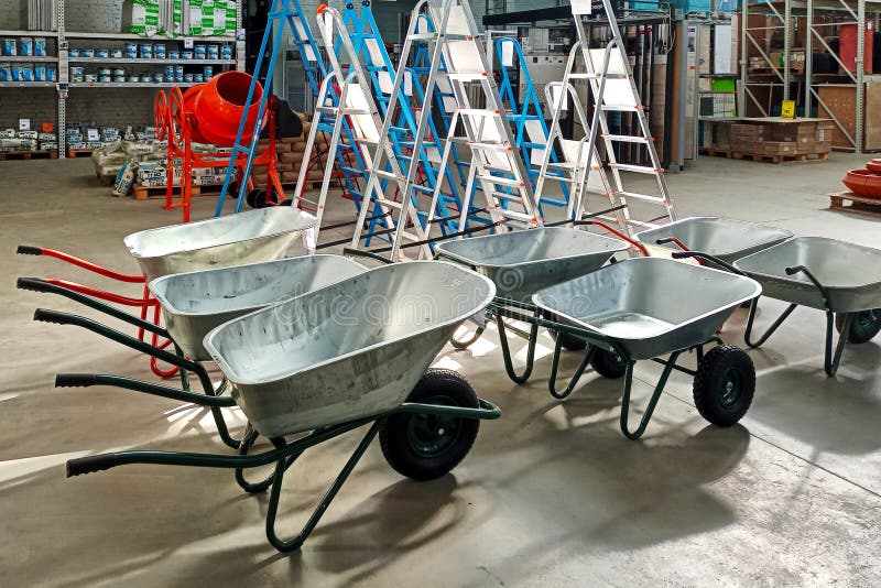 Metal Wheelbarrows and Ladders in Hardware Store Editorial Stock Photo ...