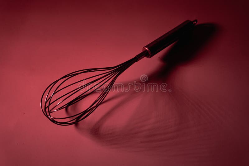 Artistic Shot of a Metal Whisk with Dramatic Red Lighting and Soft ...