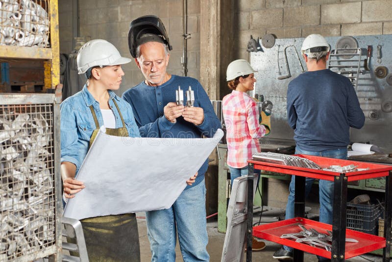 Metal Worker with Experience and Apprentice Stock Photo - Image of ...