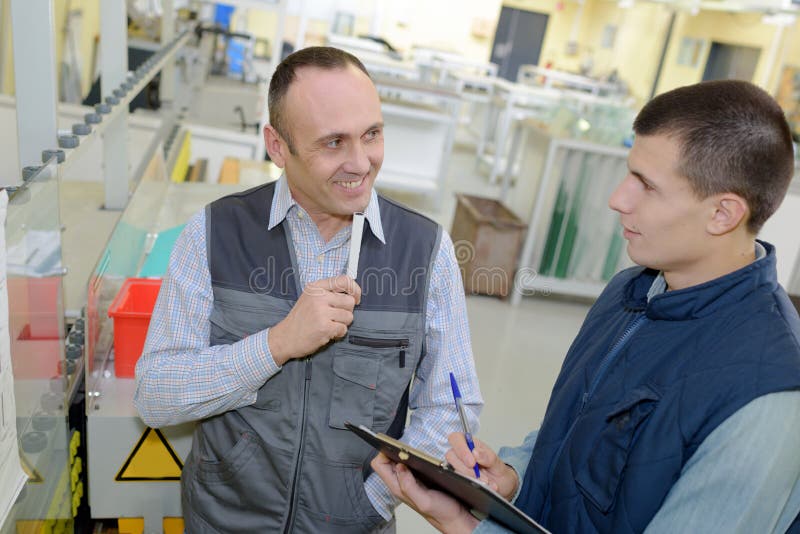 Metal Worker Showing Machine Room To Apprentice Stock Photo - Image of ...