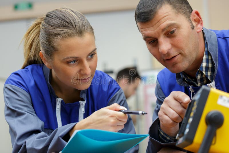 Metal Worker Teaching Trainee on Machine Use Stock Photo - Image of ...