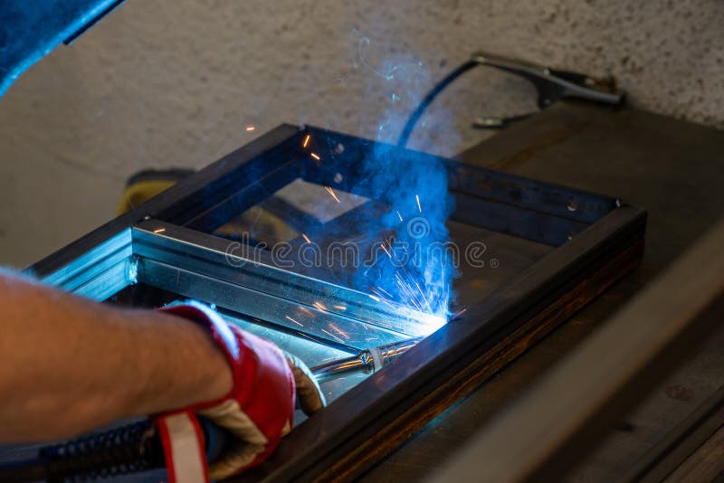 Metal Worker Welding and Fabricating a Metal Frame for a Garden Patio ...