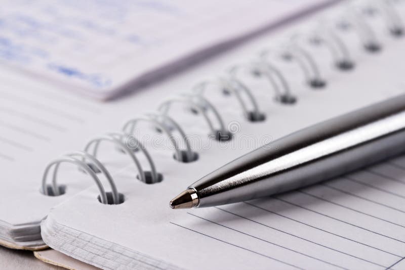 A Metallic Ball Pen on an Opened Notebook Stock Photo - Image of lines ...