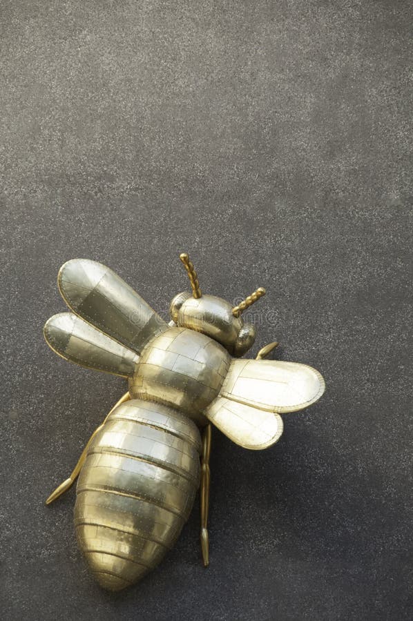 Metallic Bee Sculpture on Concrete Aggregate Wall Stock Image - Image ...