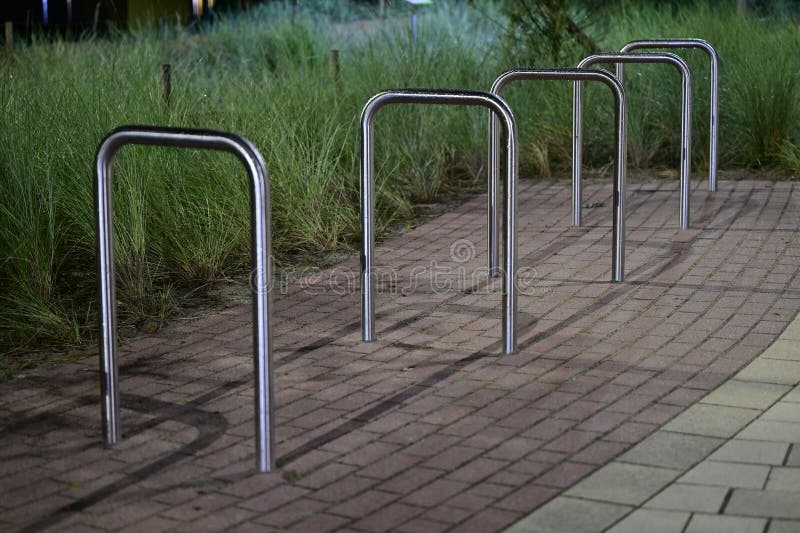 Metallic Bike Racks at Night Stock Photo - Image of guidance, shadow ...