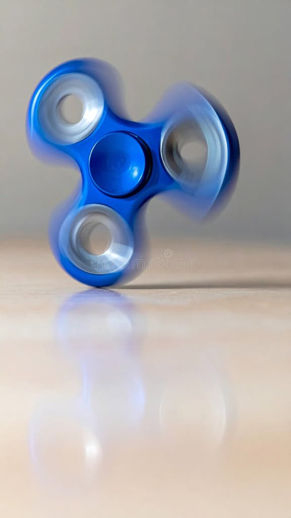 Metallic Blue Fidget Spinner Rotating with Motion Blur on Shiny ...