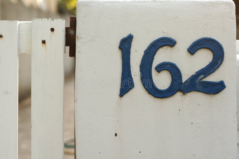 Metallic Blue House Numbers on White Picke Stock Image - Image of ...