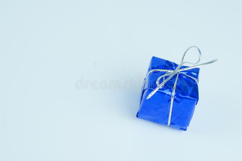 Metallic Blue Present with Silver Strings on a White Background Stock ...