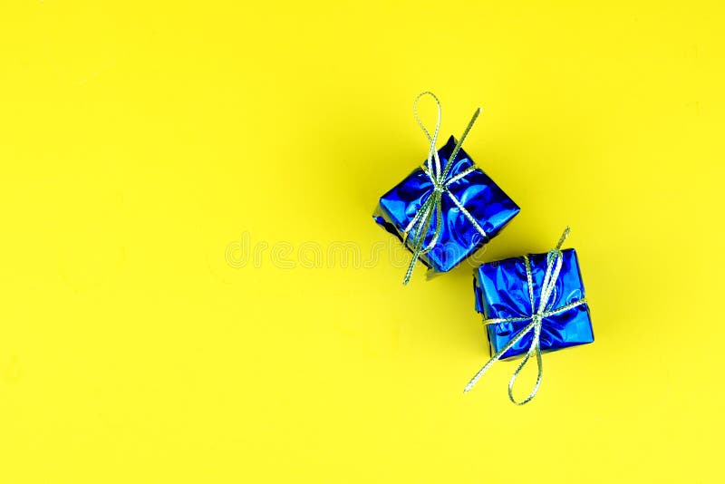Metallic Blue Present with Silver Strings on a Yellow Background Stock ...