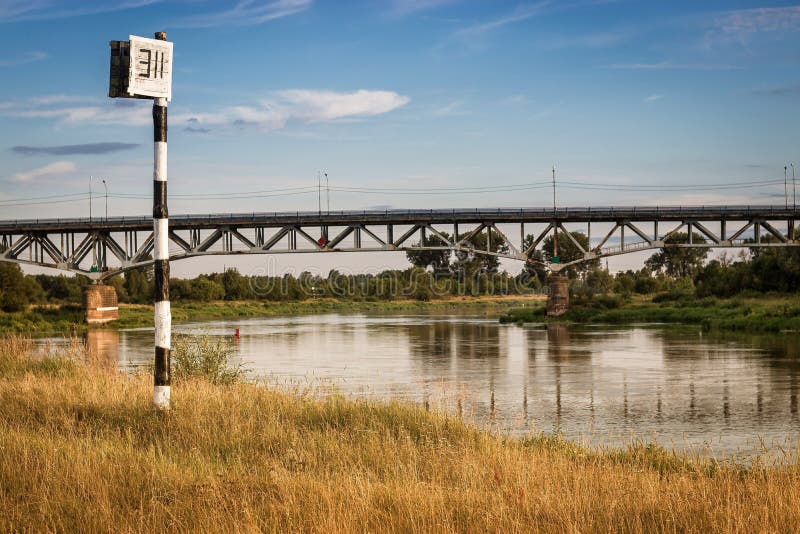 Metallic Bridge Over a River Surrounded by Yellow Fields Stock Photo ...