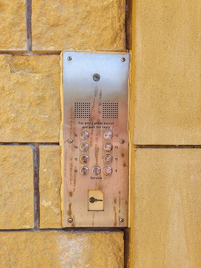 Weathered Metallic Building Access Panel Inset into a Yellow Stone Wall ...