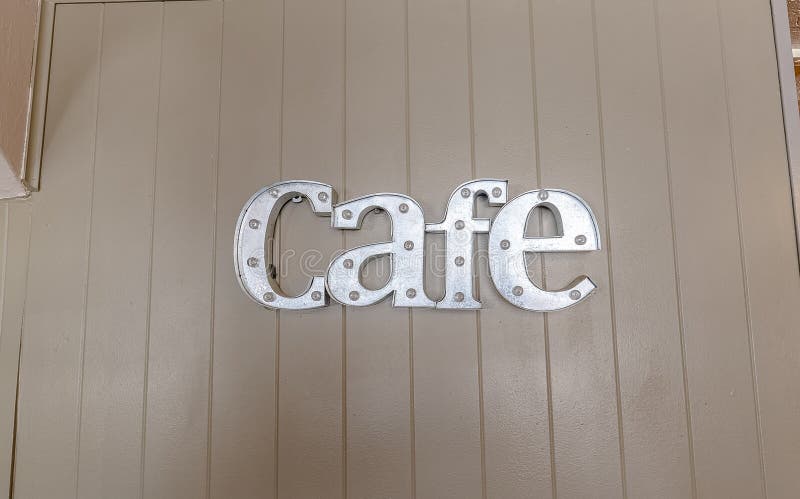 Metallic Cafe Sign on a Building Wall Stock Image - Image of board ...