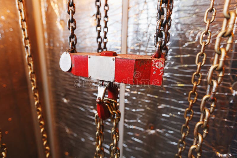 Metallic Chain Handle with Red Hook in Technical Room. Crane Cargo Hook ...