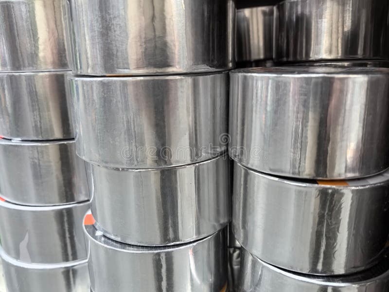 Metallic Containers Stacked Neatly in a Workshop, Reflecting Light ...