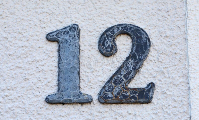A Metallic Digit Fixed on a Wall and Showing the Number Twelve on a ...
