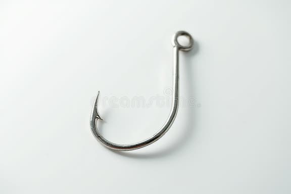 A Metallic Fishing Hook is Displayed Against a Plain White Background ...