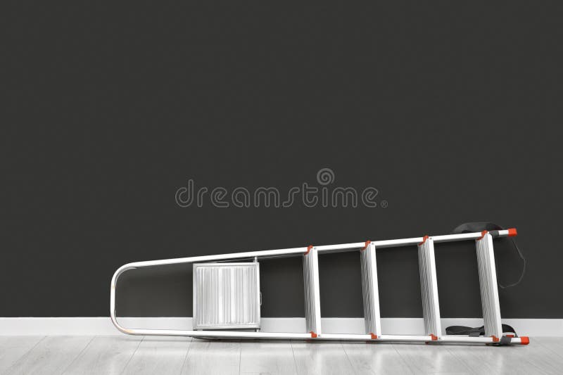 Metallic Folding Ladder Near Light Gray Wall Indoors, Space for Text ...