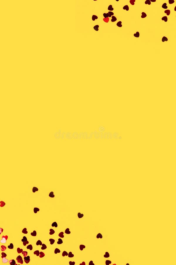 Metallic Red Confetti in a Heart Shape on a Yellow Background. Stock ...